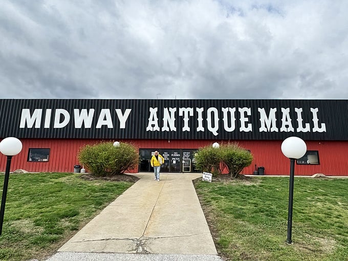 The red barn exterior of Midway Antique Mall stands like a treasure chest waiting to be opened, promising adventures in nostalgia just beyond those doors.