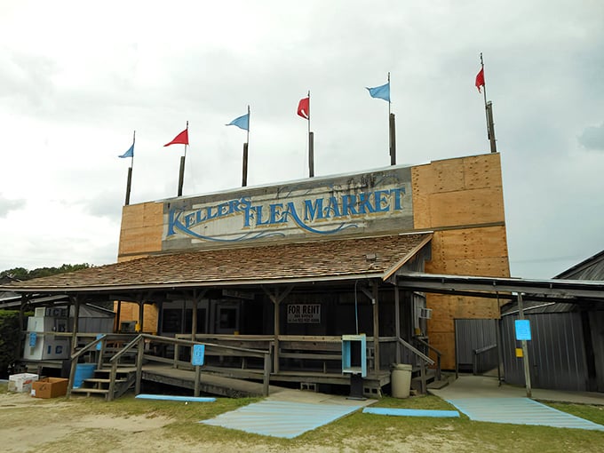 The iconic entrance to Keller's Flea Market stands proud with its colorful flags waving a welcome to treasure hunters and casual browsers alike.