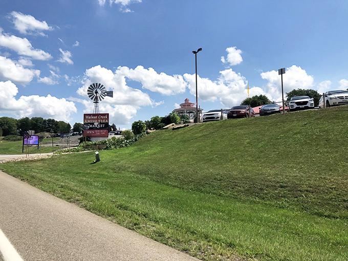 The iconic windmill sign welcomes bargain hunters to Walnut Creek Marketplace, where Amish Country charm meets treasure-hunting paradise under Ohio's big blue sky.