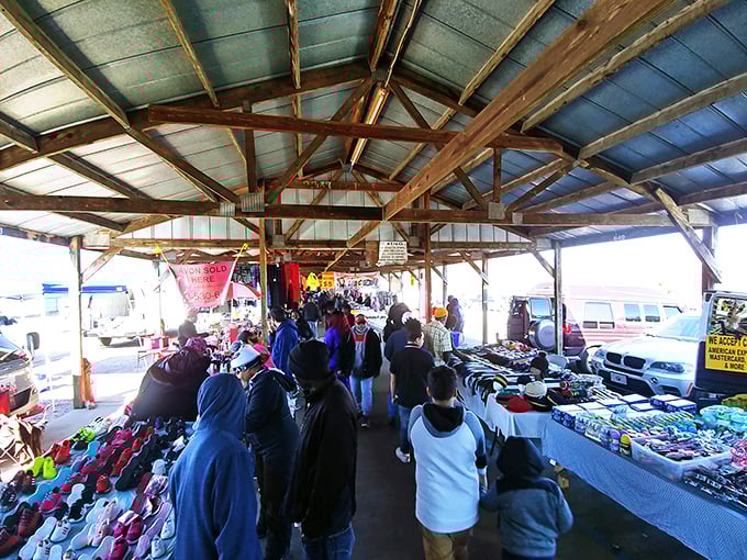 The covered pavilions at US 1 Metro Flea Market buzz with weekend energy as shoppers hunt for treasures among tables laden with colorful merchandise.