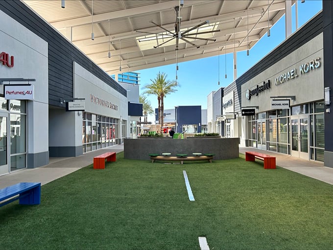 The modern walkways at Tanger Outlets feature lush green spaces where shoppers can rest their weary credit cards between retail adventures.