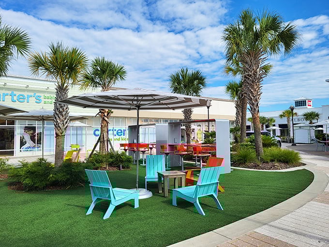 Those teal Adirondack chairs aren't just for show – they're strategic resting spots for when your shopping bags outweigh your arm strength.