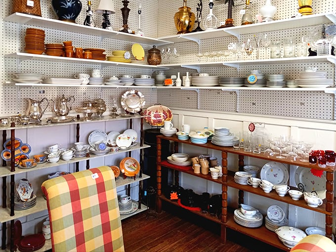 The charming cottage-style exterior of ReTails Thrift Shop beckons with its bright red roof and white picket fence—a treasure hunt disguised as a building.