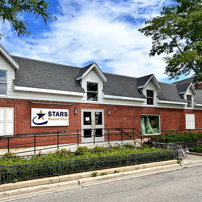 The charming brick facade of STARS Resale Shop welcomes bargain hunters with its distinctive blue and yellow signage, promising treasures waiting to be discovered inside.