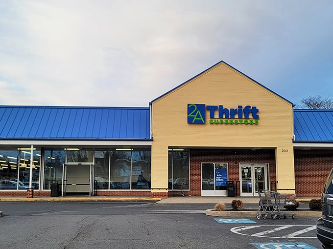 The beige and brick exterior of 2nd Ave Thrift Superstore stands like a temple to secondhand treasures, its blue and green sign beckoning bargain hunters.