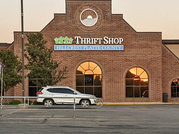 The iconic brick facade of Hillcrest Thrift Shop glows at sunset, promising treasure hunters adventures beyond those arched windows.