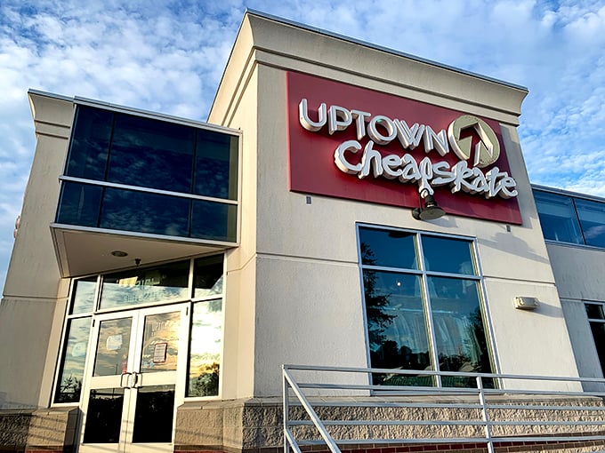The modern storefront of Uptown Cheapskate stands out with its bold red signage, promising treasure hunters a stylish secondhand adventure.