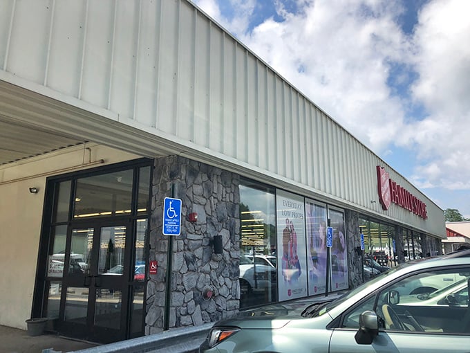 The unassuming exterior of treasure-hunting paradise – where bargain dreams come true behind that stone facade and practical signage.