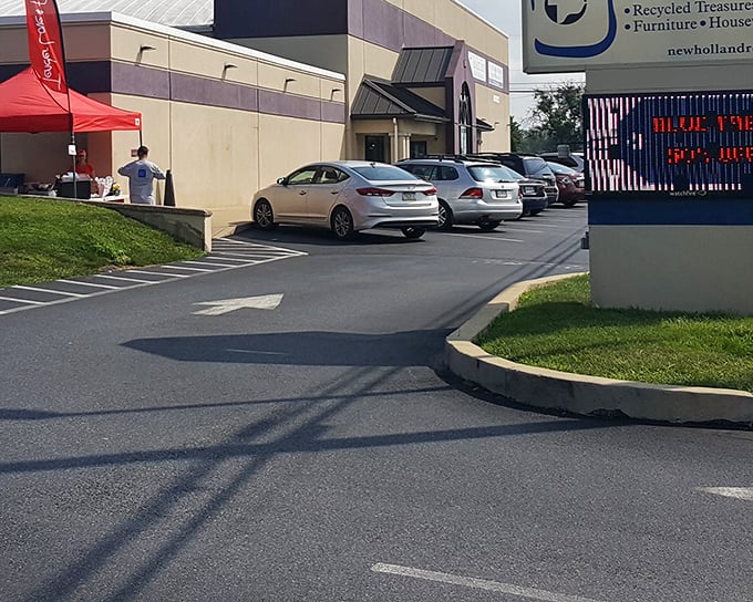 Even the parking lot hints at treasures within. That red tent suggests a special event—thrifters know the best days to visit.