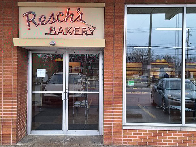 The glowing red neon sign of Resch's Bakery beckons like a lighthouse for the sugar-deprived, promising sweet salvation behind those unassuming brick walls.