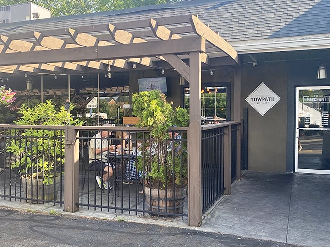 Twilight transforms this Akron patio into an urban oasis. String lights twinkle overhead like stars, promising memorable meals under the wooden pergola.