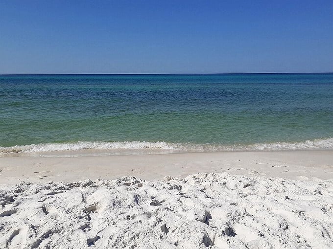 Nature's own watercolor masterpiece. The sunset paints cotton candy clouds over emerald waters while sea oats stand guard like nature's velvet rope.