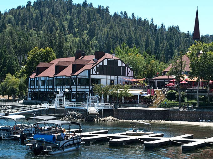 The quintessential Lake Arrowhead view—Tudor-style buildings nestled against emerald pines with that impossibly blue water. Mother Nature showing off again.