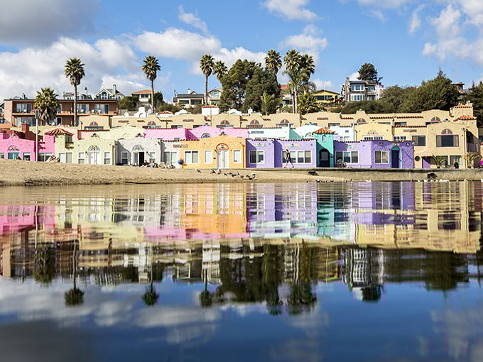 The famous candy-colored Venetian Court reflects perfectly in Soquel Creek, creating a double rainbow of architectural delight that defines Capitola's unique charm.