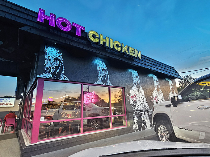 The bold black exterior with its pink accents and chicken illustrations isn't just design – it's a declaration that this isn't your grandma's fried chicken joint.