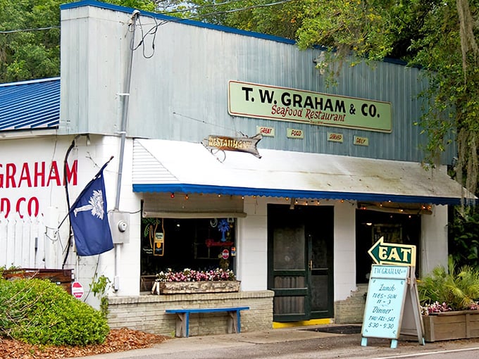 The blue metal exterior with "God Bless Our Shrimpers" chalked on the window tells you everything: this isn't fancy, but it's the real South Carolina deal.