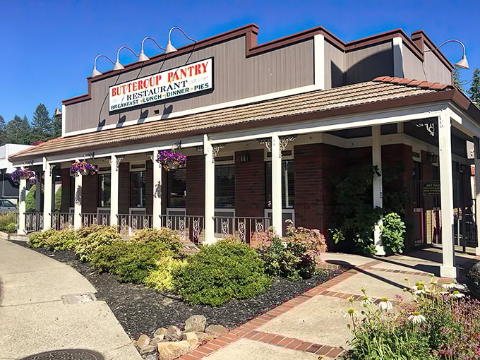 The welcoming facade of Buttercup Pantry stands like a time capsule in Placerville, its brick exterior and hanging flower baskets promising comfort before you even step inside.