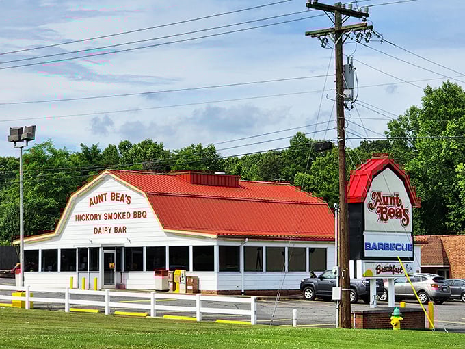 The iconic red-roofed building stands like a barbecue beacon, promising hickory-smoked delights that have made it a North Carolina pilgrimage site.