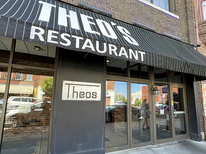 The unassuming black awning of Theo's Restaurant stands as a beacon for hungry travelers – Cambridge's culinary landmark hiding in plain sight.