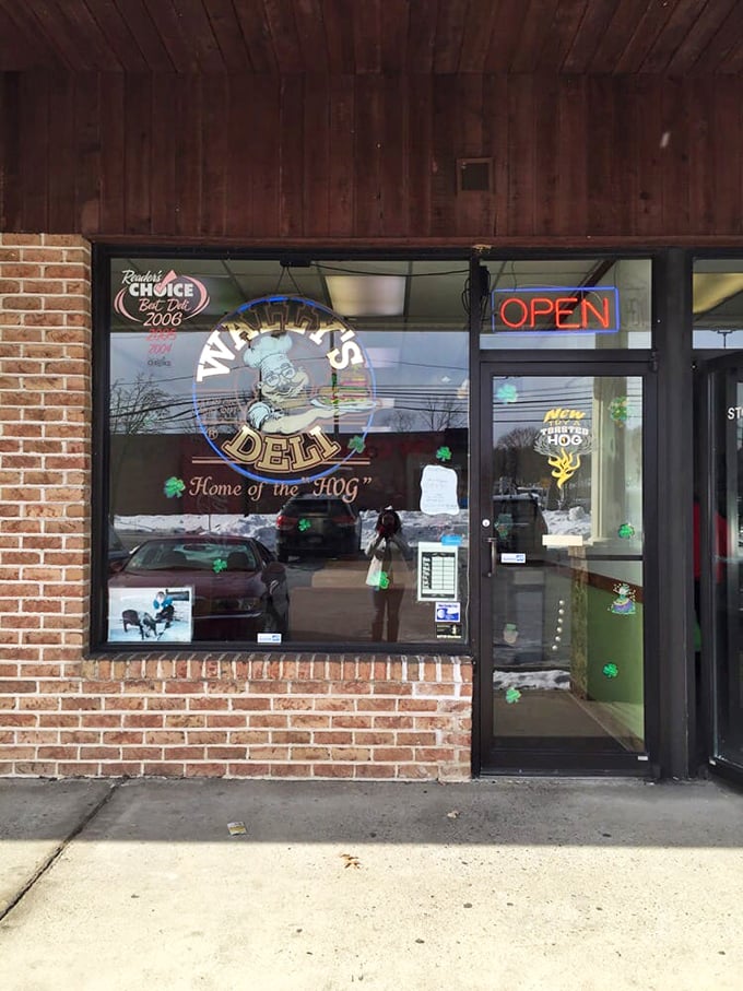 The unassuming storefront of Wally's Deli proudly declares itself "Home of the HOG" – a promise that sandwich lovers know is gloriously fulfilled inside.