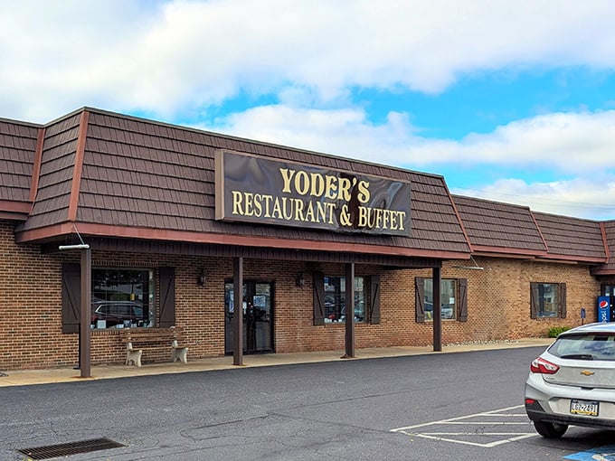 The brick exterior of Yoder's welcomes hungry travelers with its wooden shutters and simple signage – like a warm handshake before the culinary embrace inside.