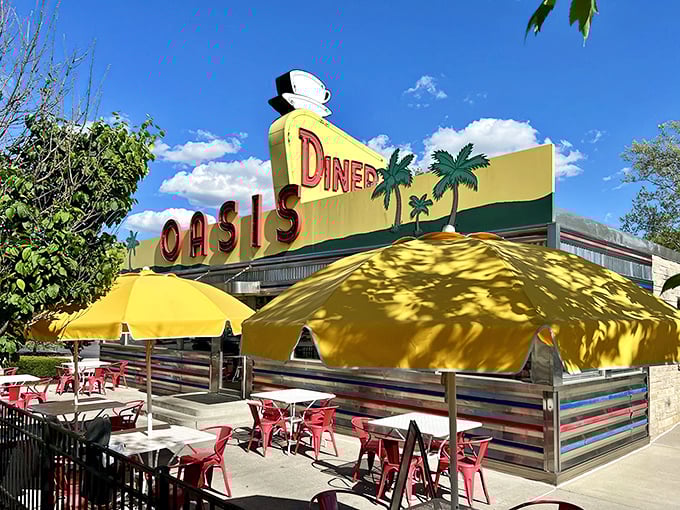 The sunshine-yellow exterior of Oasis Diner gleams like a beacon of hope for hungry travelers—mid-century Americana preserved in all its neon glory.