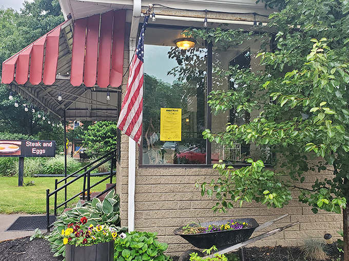 The unassuming exterior of The Diner beckons with its cheerful red umbrellas and lush planters—proof that culinary treasures often hide in plain sight.