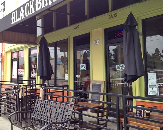Those purple umbrellas aren't just for show—they're sheltering future food memories and the distinctive penny-farthing bike rack adds whimsical charm to this neighborhood gem.