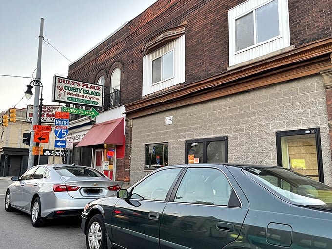 Detroit's architectural history frames Duly's Place perfectly—brick buildings and that unmistakable red awning signaling comfort food ahead.