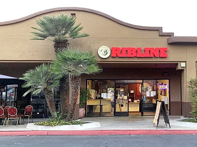 The unassuming storefront that launches a thousand food pilgrimages. Palm trees stand guard outside this temple of barbecue, as if whispering, "Prepare your napkins."
