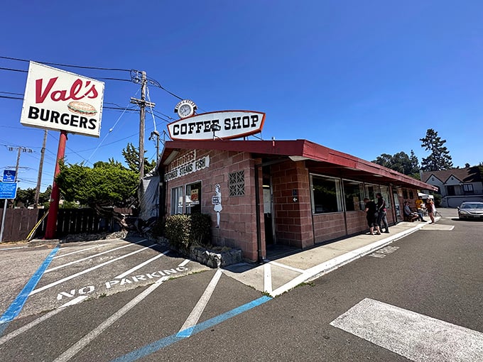 The classic mid-century sign beckons like a time-traveling invitation. Val's Burgers stands proudly against the California sky, promising honest food and zero pretension.
