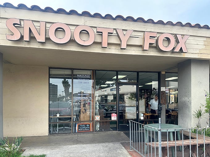 The unassuming storefront of Snooty Fox belies the culinary treasures within. Like finding a Picasso at a yard sale, this modest exterior hides breakfast brilliance.