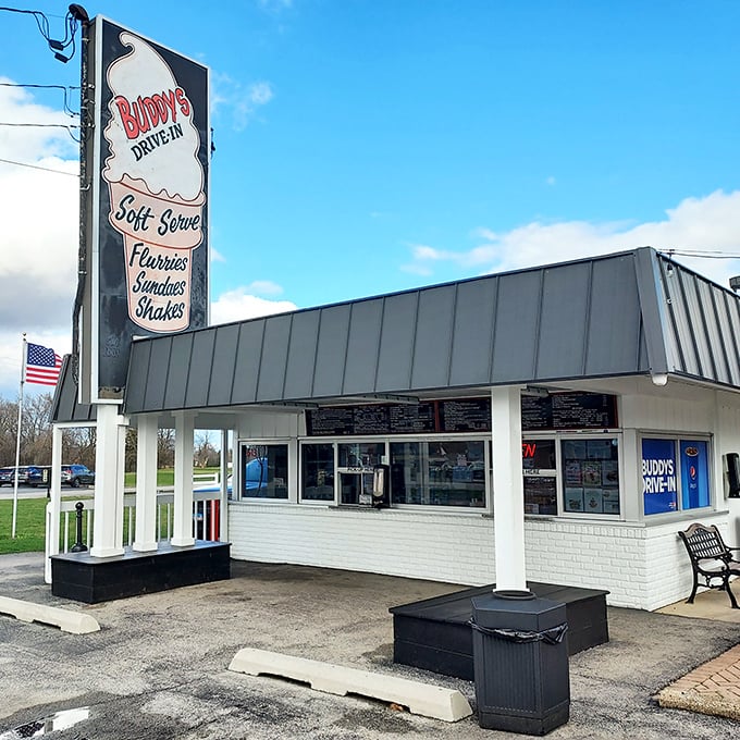 The iconic Buddy's Drive-In sign stands tall against the Illinois sky, promising frozen delights that have drawn generations of sweet-toothed pilgrims to Beecher.
