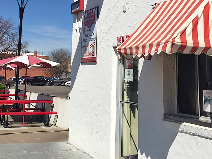 That classic red and white awning isn't just decoration—it's a portal to a simpler time when burgers were small and satisfaction was huge.