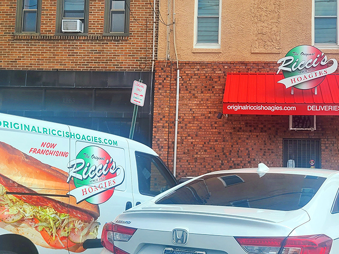The unassuming brick exterior of Ricci's Hoagies stands as South Philly's sandwich sanctuary, where the neon sign promises—and delivers—hoagie perfection.