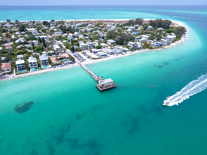 Aerial paradise where turquoise waters embrace shoreline homes. This isn't a Caribbean postcard—it's Anna Maria Island, Florida's best-kept retirement secret.
