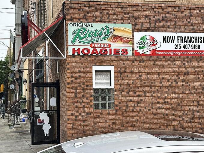 The unassuming brick exterior of Ricci's Hoagies stands as South Philly's sandwich sanctuary, where the neon sign promises—and delivers—hoagie perfection.
