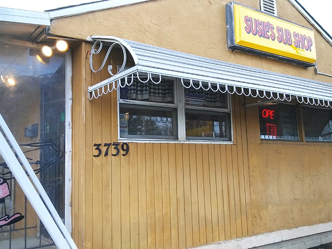 The humble yellow sign of Susie's Sub Shop beckons like a lighthouse to sandwich seekers. No fancy frills, just the promise of honest-to-goodness deliciousness inside.