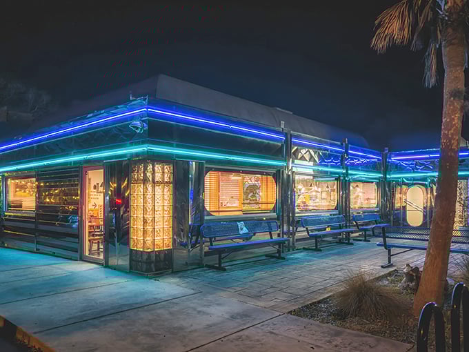 The neon glow of Pink Flamingo Diner at night isn't just illumination—it's an invitation to step into a world where comfort food meets Florida charm.