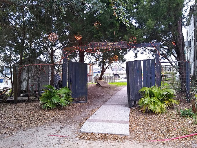 The entrance to culinary paradise isn't always grand – this weathered gate with twinkling lights promises the kind of authentic experience that fancy restaurants can only pretend to offer.