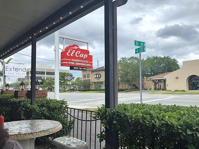 The iconic red and white El Cap sign stands proudly at 4th Street North, beckoning burger lovers like a lighthouse for the hungry.
