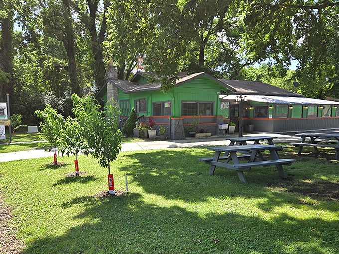 The little green house that could! Peachtree Neighborhood Grill's vibrant exterior and picnic tables invite you to slow down and savor Nashville's hidden culinary gem.