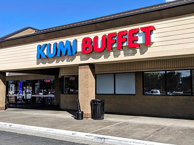 The blue and red sign beckons like a lighthouse for hungry souls. Kumi Buffet's modest exterior hides culinary treasures within.
