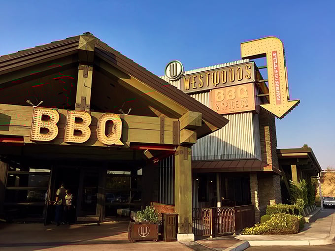 That neon sign isn't just calling you to dinner—it's practically sending up smoke signals visible from three counties away. Westwoods BBQ stands proud against the California sky.