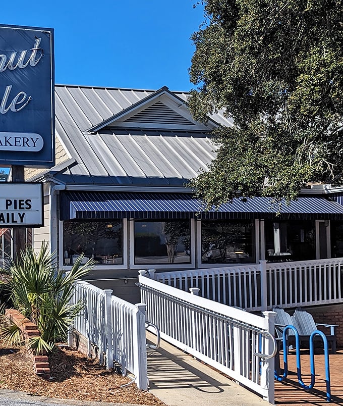 The iconic blue-trimmed exterior of Donut Hole beckons like a siren song to hungry travelers. That white picket fence isn't just charming—it's crowd control for the breakfast rush!