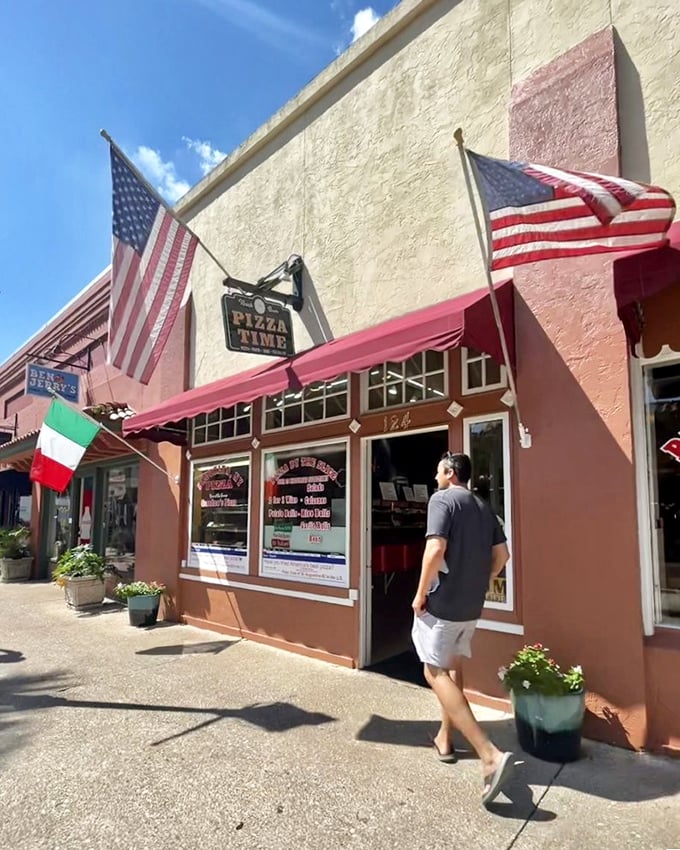 A pizza pilgrimage in progress as a customer approaches the hallowed grounds of Pizza Time. Some journeys are measured in miles, others in slices.