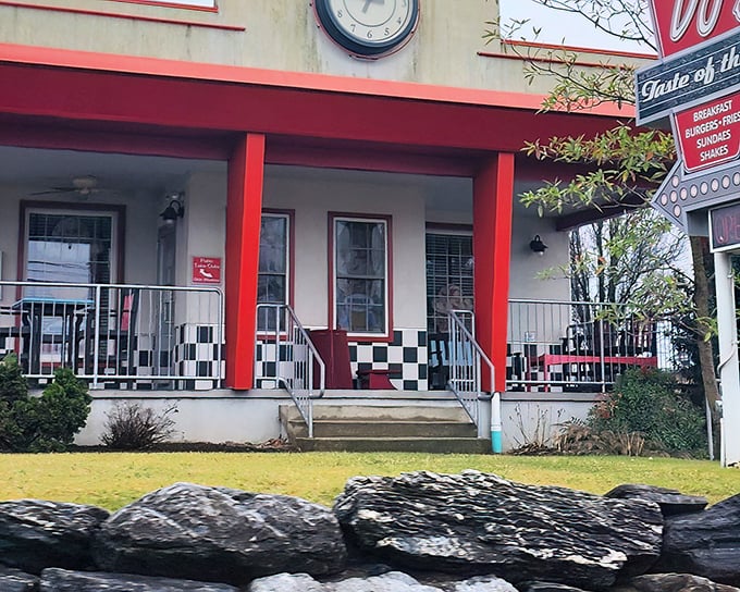 The classic red-trimmed exterior with checkerboard porch isn't just nostalgic design—it's a time portal disguised as a diner entrance.