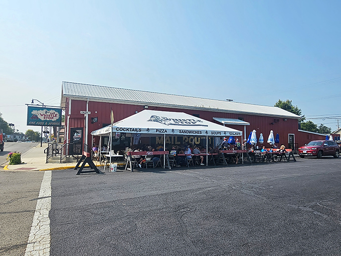 The red barn exterior of Whistle Stop isn't just charming—it's a beacon for hungry travelers. That outdoor seating area practically whispers "stay awhile."