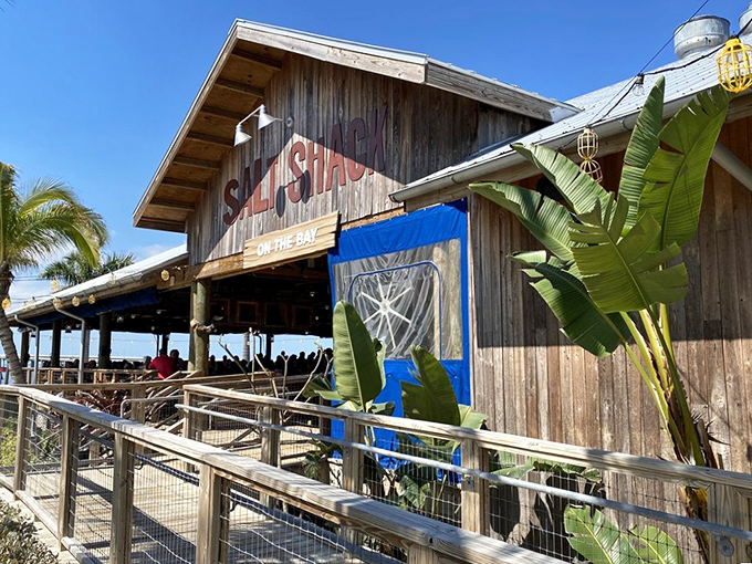 The weathered wooden exterior of Salt Shack on the Bay isn't trying to impress you—it's saving all that energy for what's on your plate.