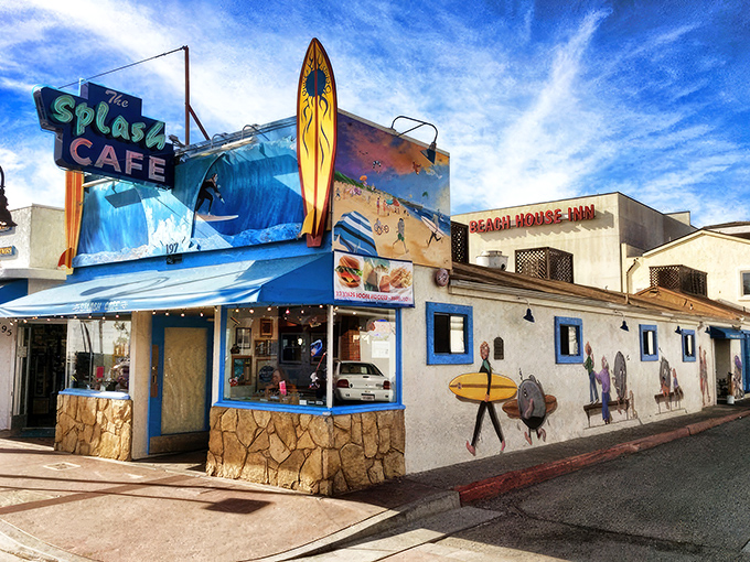 The iconic blue facade of Splash Cafe stands like a beacon of seafood salvation on Pismo Beach's shoreline, complete with surfboard sentinels guarding the entrance.